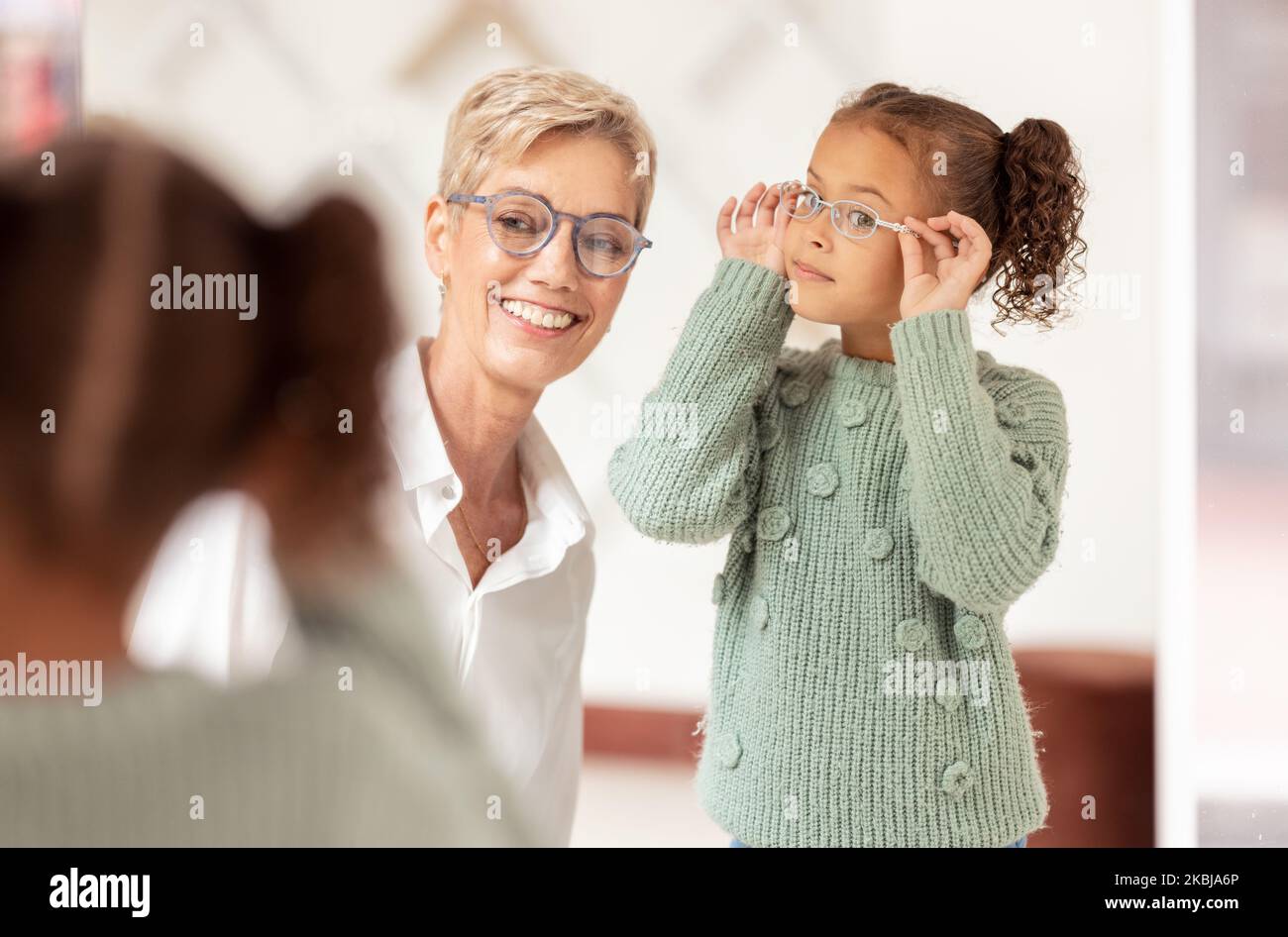 Eyes, consulting and glasses by girl and optometrist woman at optician ...