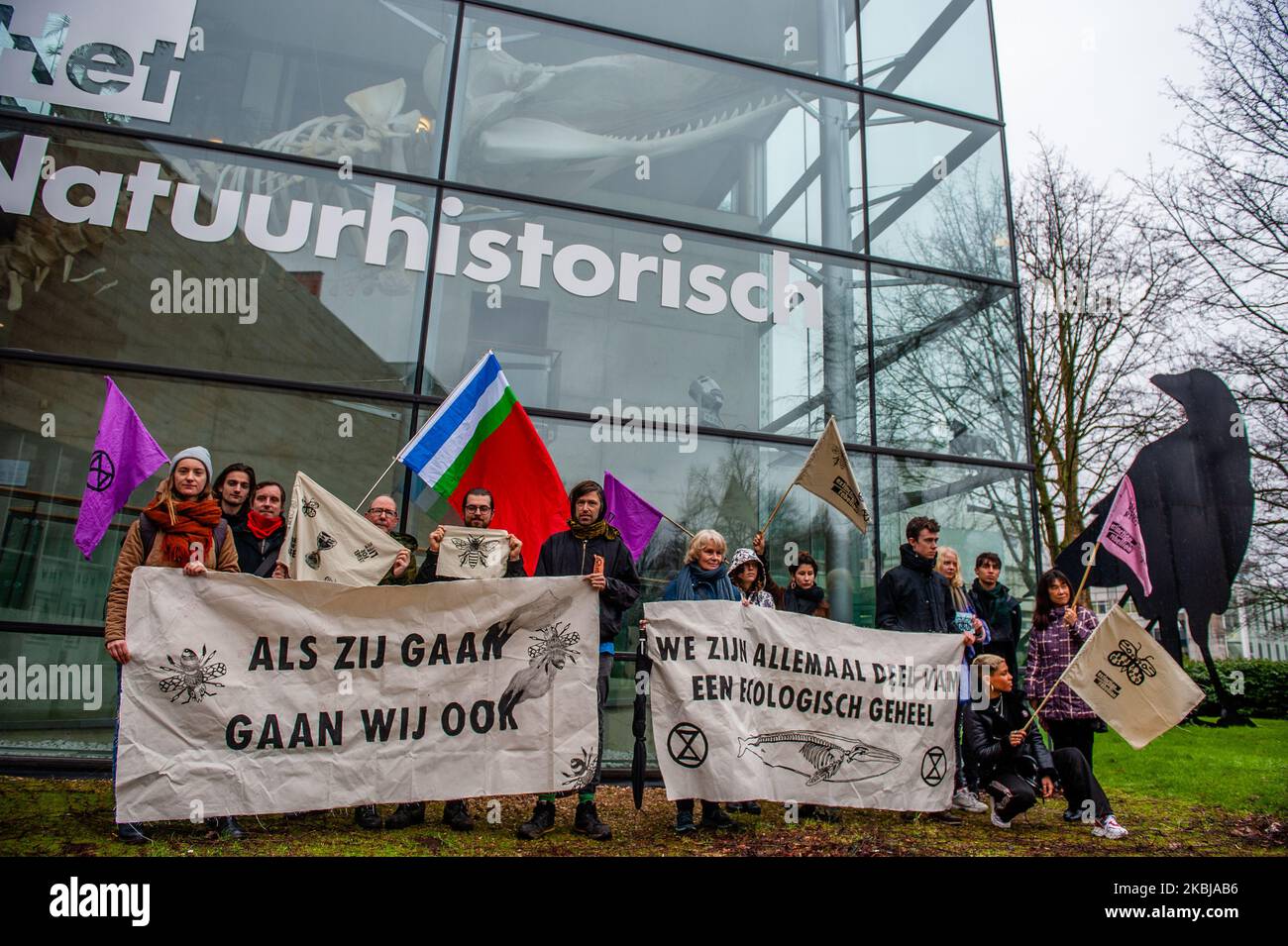 A group of Extinction Rebellion activists are posing with banners and ...