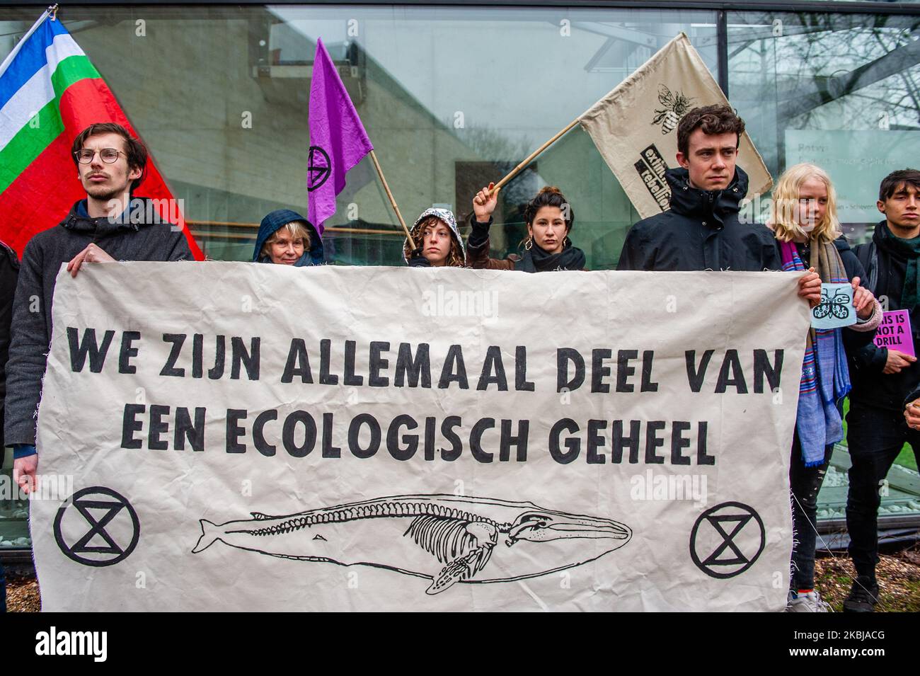 A group of Extinction Rebellion activists are posing with banners and ...
