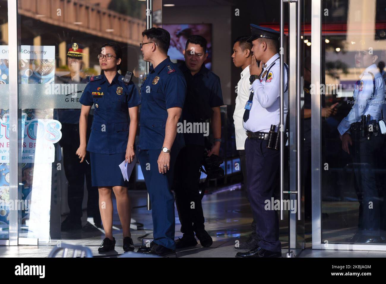 Authorities secure the entrance of a mall in San Juan City, east of ...