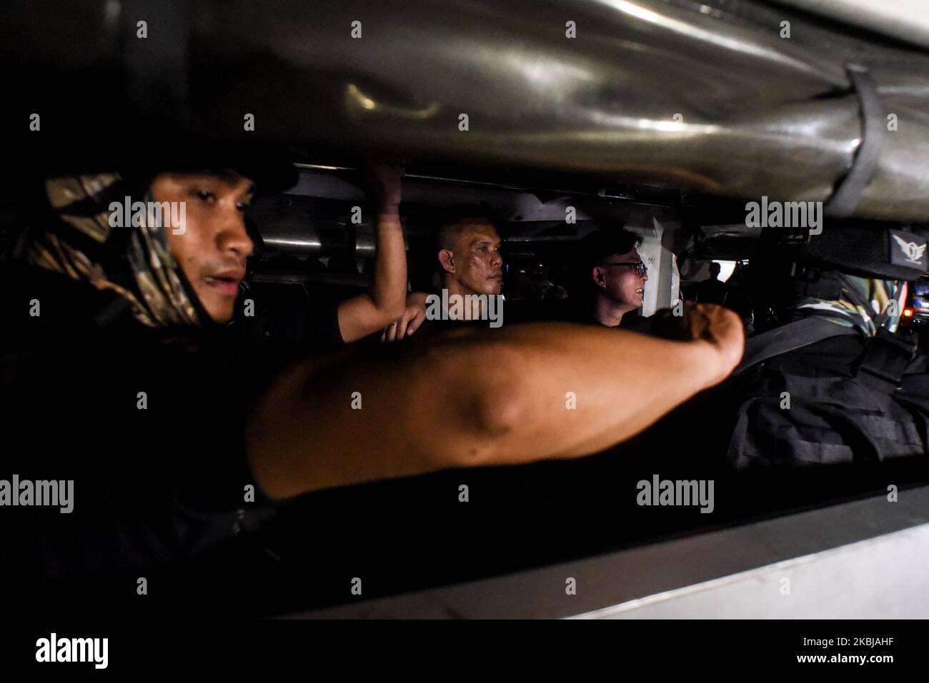 Police officers secure the suspect outside a mall in San Juan City ...