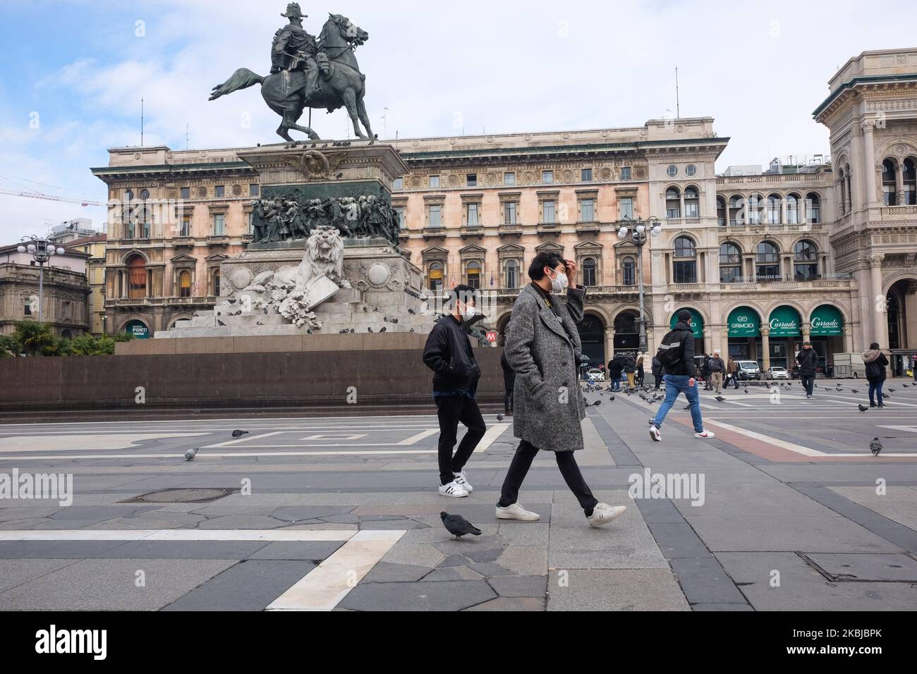 Two tourists are wearing a protective mask because of the Coronavirus ...