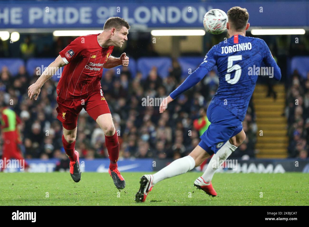 James Milner of Liverpool heading the ball past Jorginho of Chelsea ...