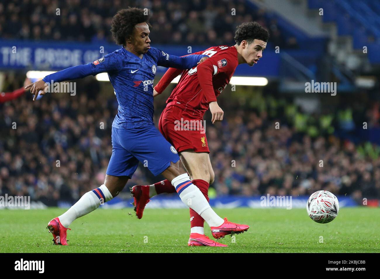 Curtis Jones of Liverpool passing the ball past Willian of Chelsea ...