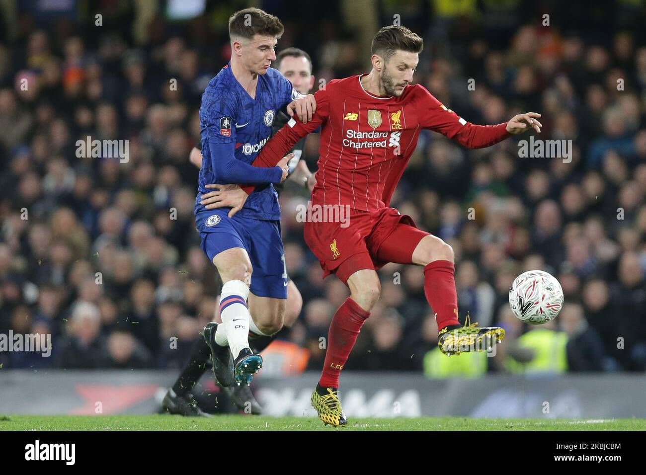 Adam Lallana of Liverpool holding off Mason Mount of Chelsea during the ...
