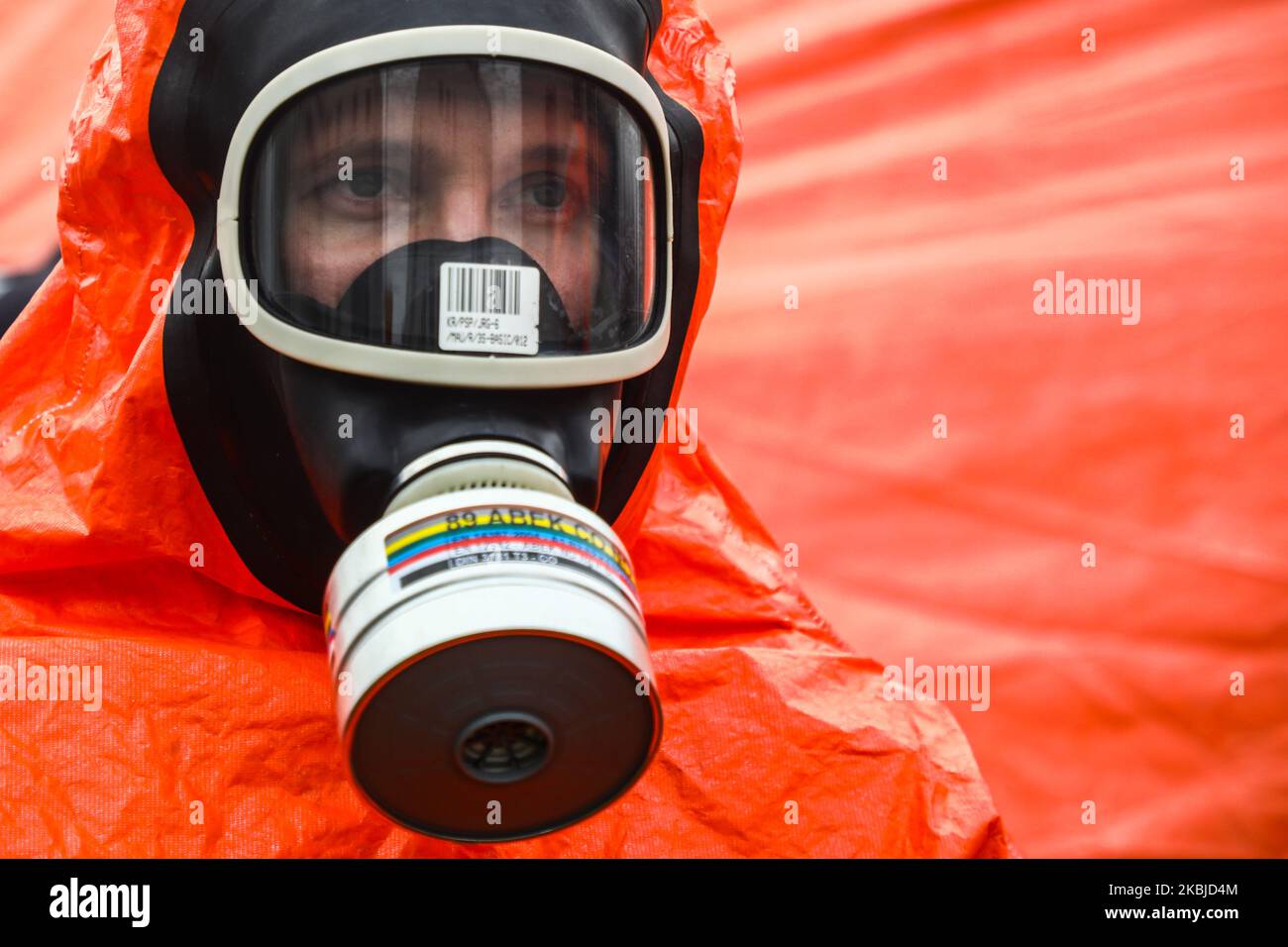 Personel wearing protective masks and suits is pictured in front of ...