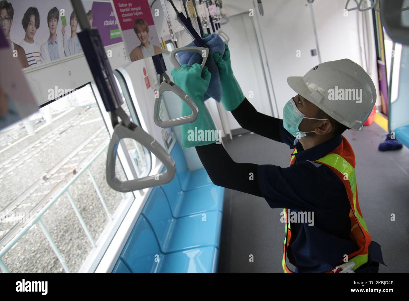 Officers clean the MRT Jakarta train interiors with disinfectant liquid ...