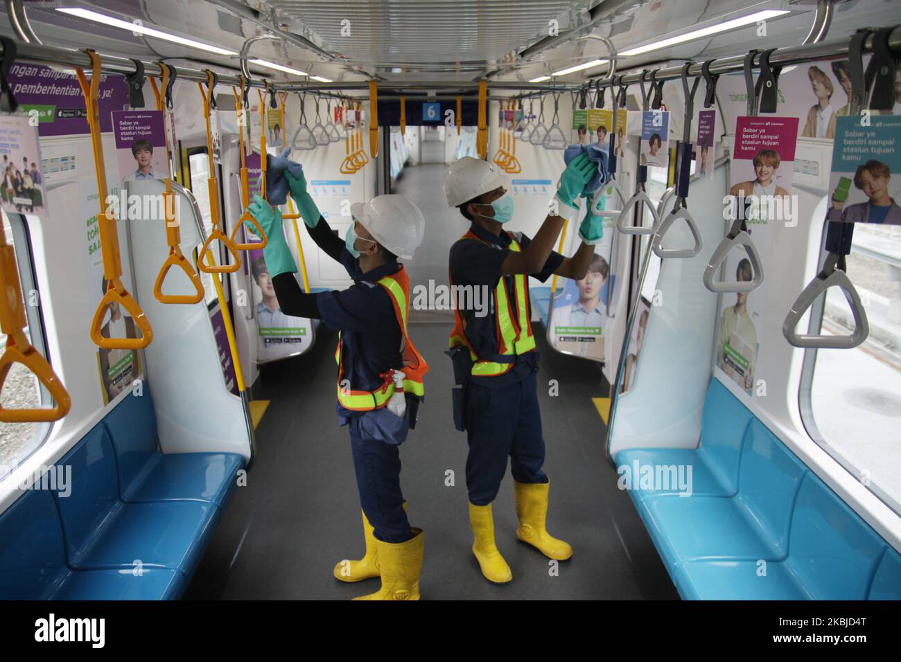 Officers clean the MRT Jakarta train interiors with disinfectant liquid ...