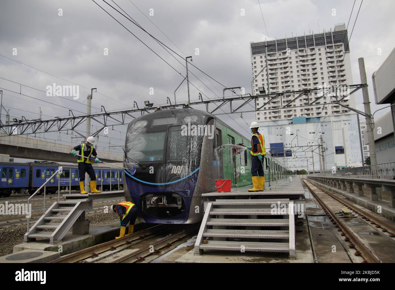 Officers clean the MRT Jakarta train interiors with disinfectant liquid ...