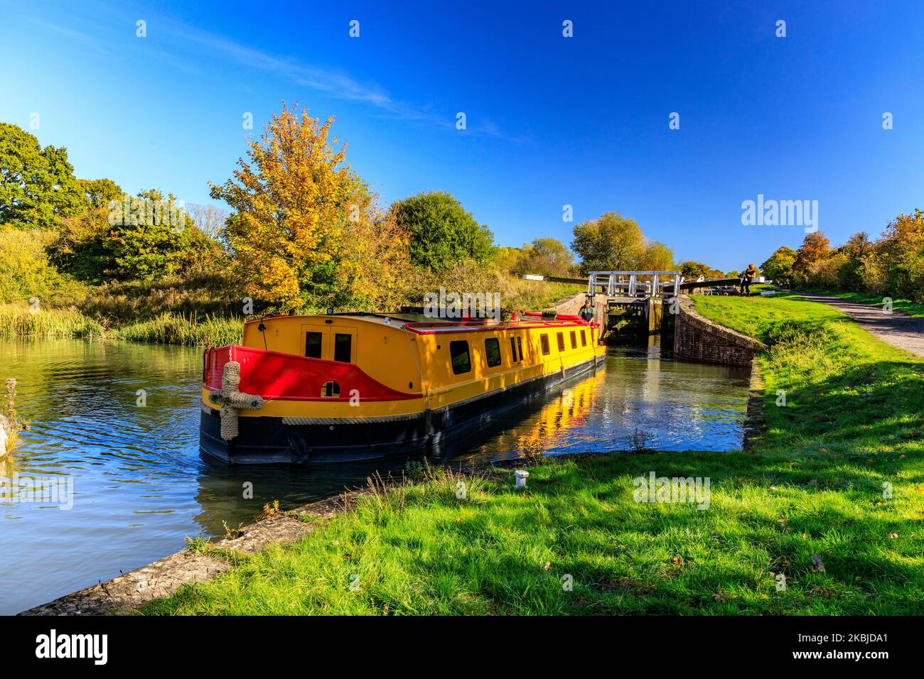 A colourful wide beam canal boat negotiating one of the 29 locks at ...