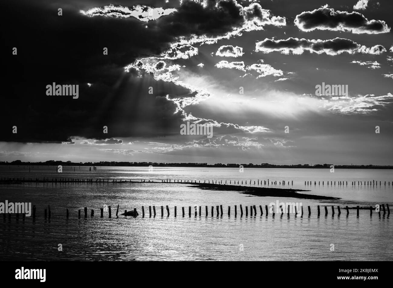 Towards the sunset. Marano lagoon late summer colors. Clouds and sun ...