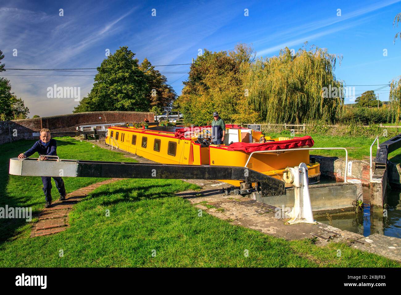 A colourful wide beam canal boat negotiating one of the 29 locks at ...