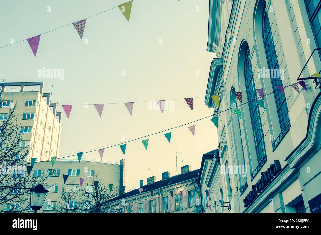 colorful festive flags in streets of town Stock Photo - Alamy