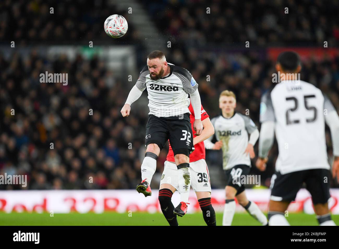 Wayne Rooney (32) of Derby County heads the ball clear during the FA ...