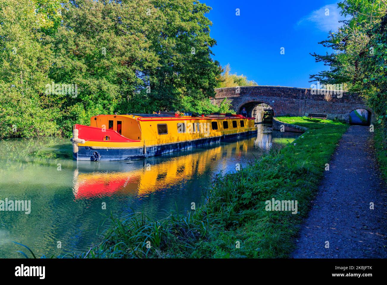 A colourful wide beam canal boat between two of the 29 locks at Caen ...