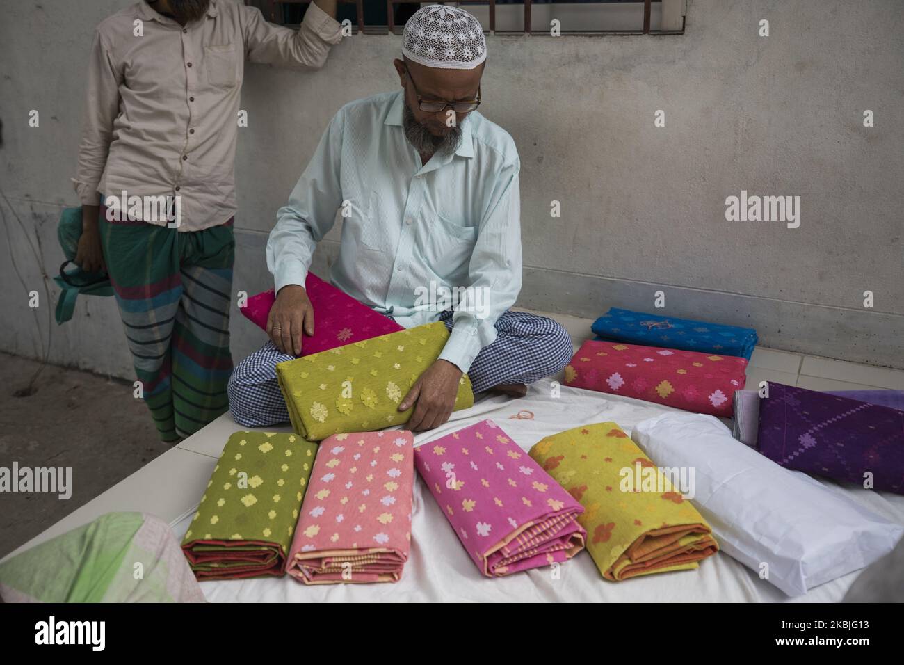Handloom weaver weaves Jamdani saree on a traditional wooden hand weaving loom at Demra Jamdani ...