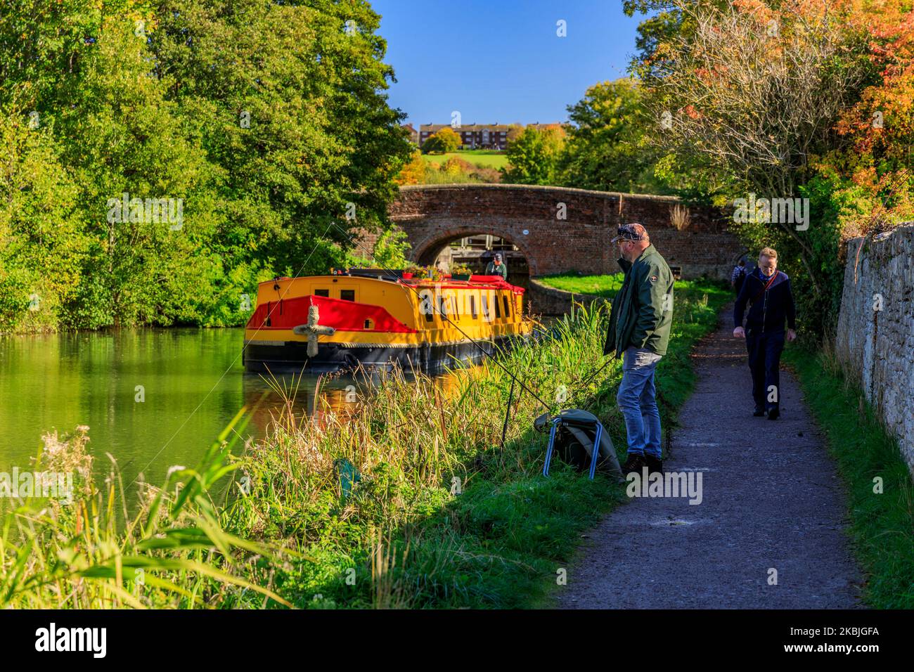 A colourful wide beam canal boat between two of the 29 locks at Caen ...