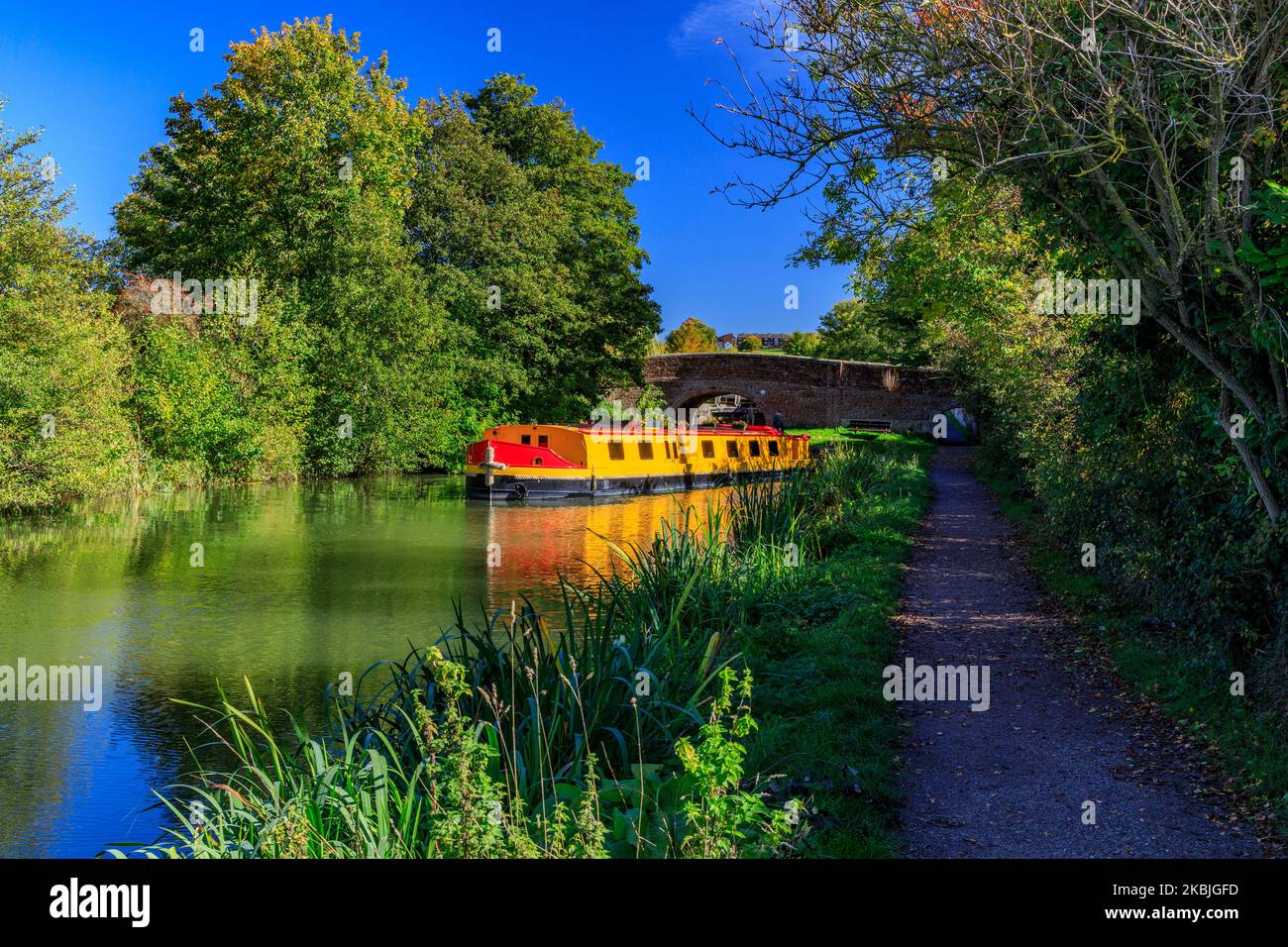 A colourful wide beam canal boat between two of the 29 locks at Caen ...
