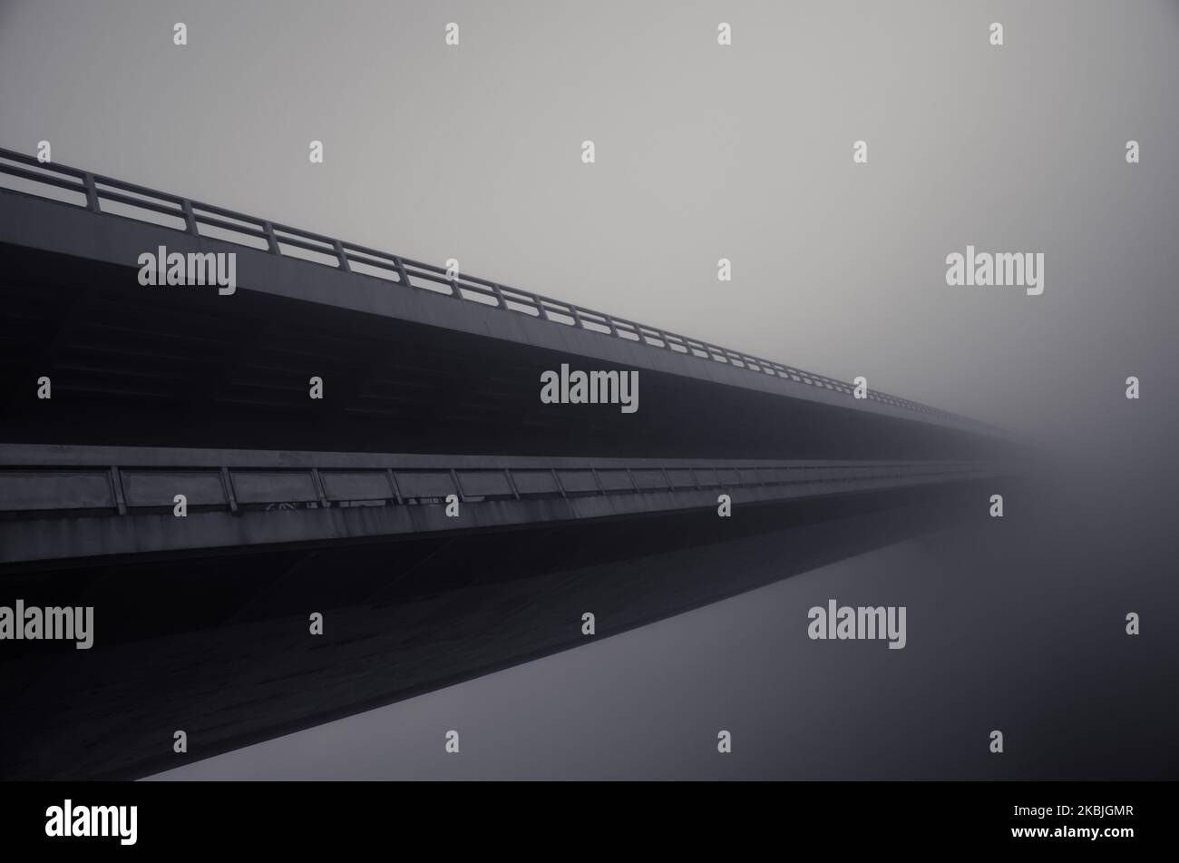 long bridge over water in fog Stock Photo - Alamy
