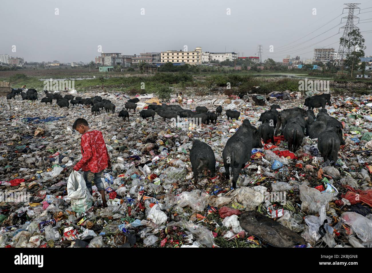 A child collects resell able belongings to sell from the trash while ...