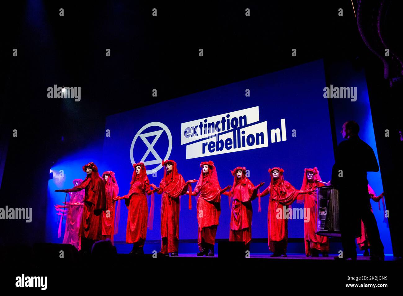 The Rebel Brigade from Extinction Rebellion is performing on the stage ...