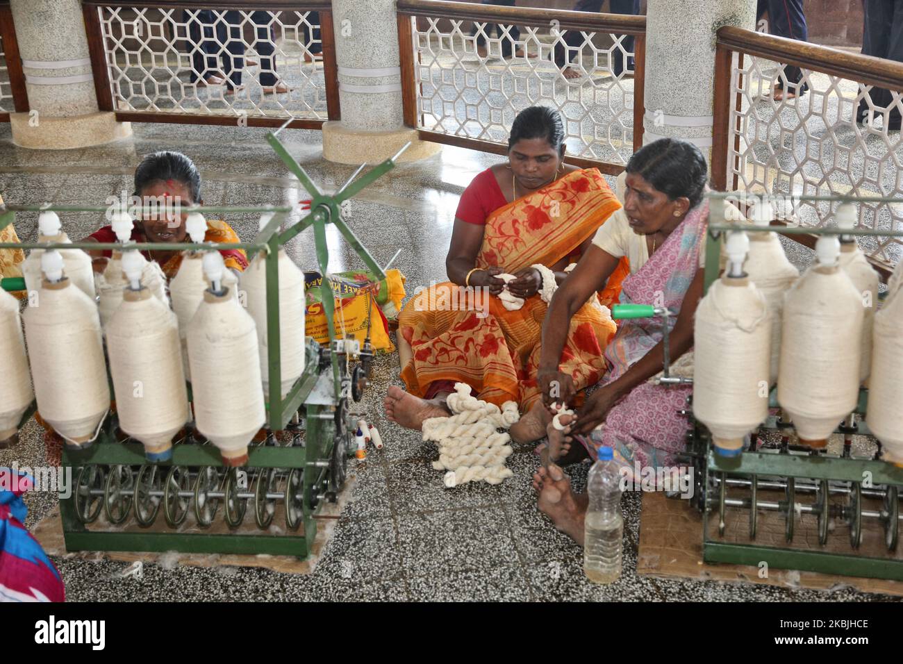 Women using modern machines to spin wool into yarn at the Gandhi ...