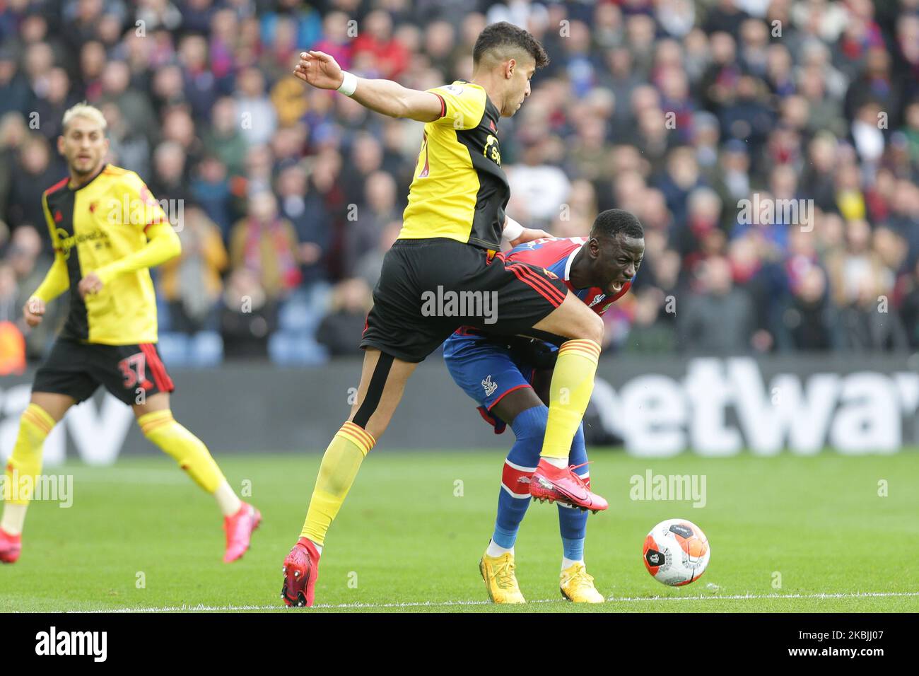 Adam Masina of Watford tackling Cheikhou Kouyate of Crystal Palace ...