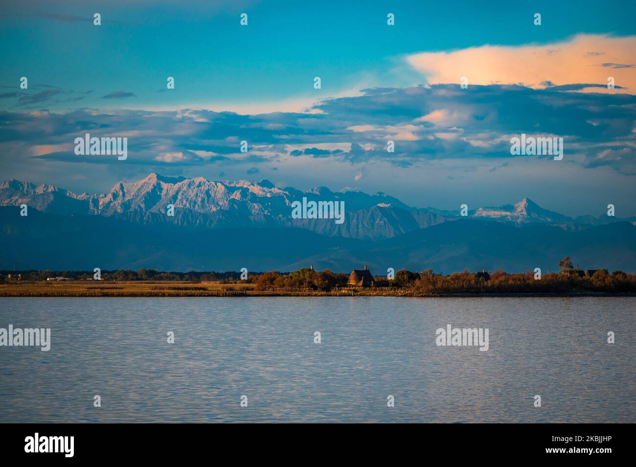 Towards the sunset. Marano lagoon late summer colors. Clouds and sun ...