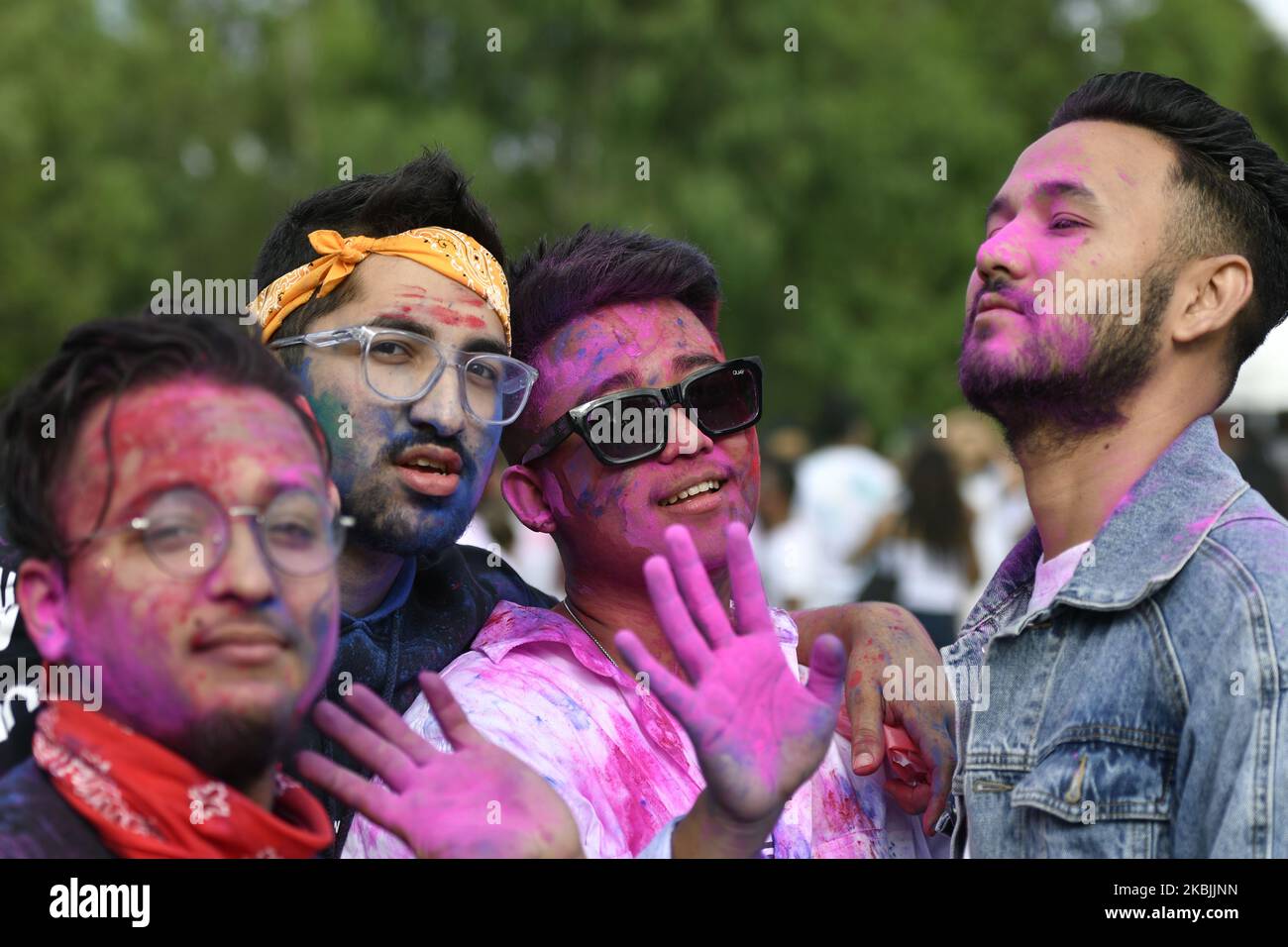 People play with colors and water as they celebrate Holi festival ...