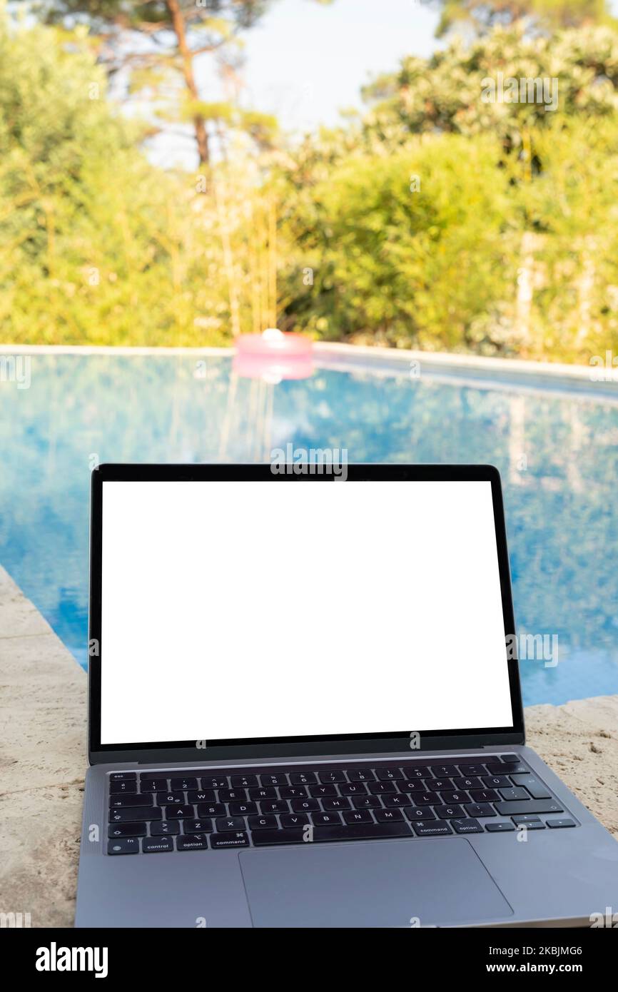 Modern laptop mock up white blank screen for hotel, resort, villa, holiday ad concept idea with ...