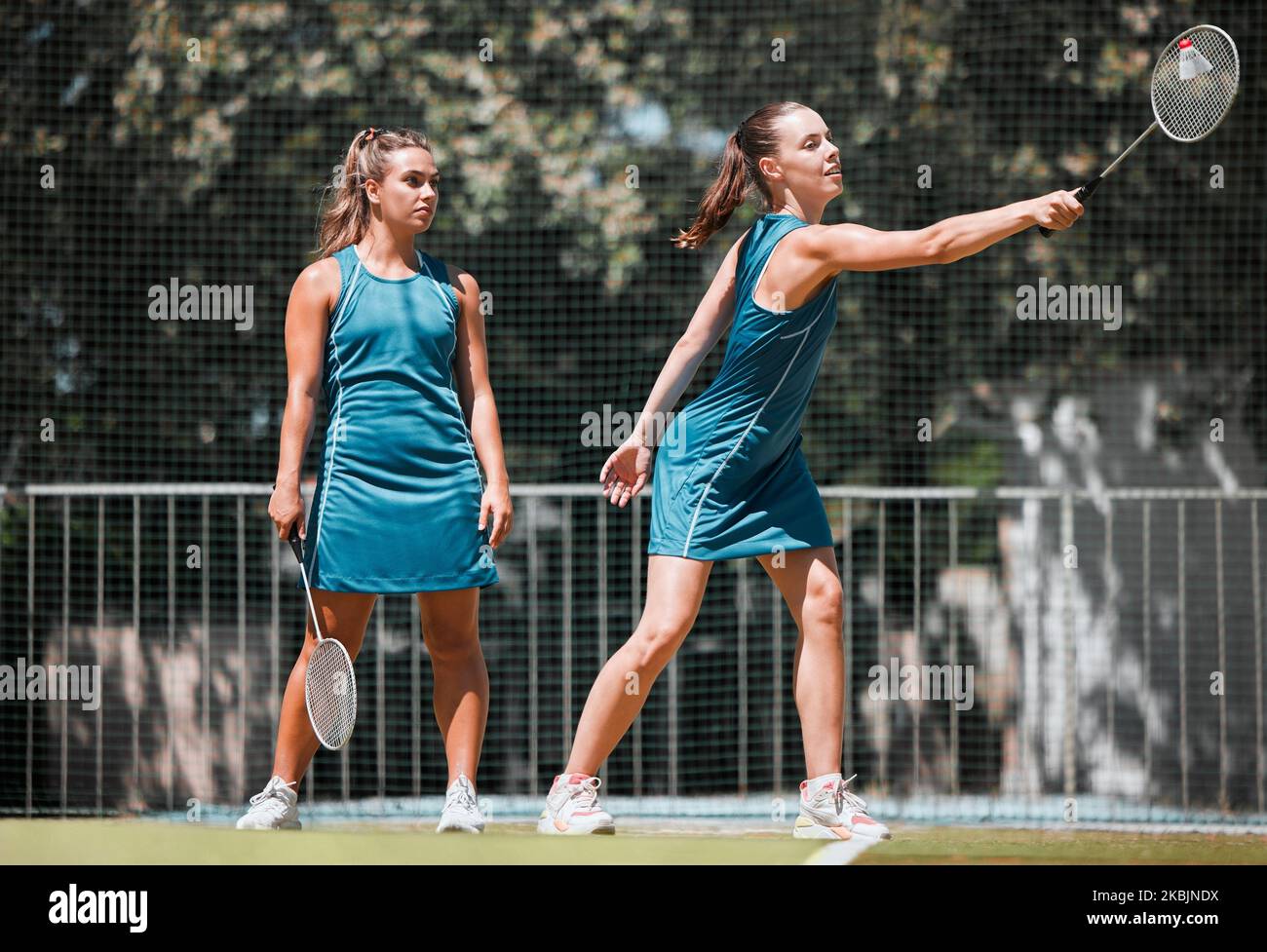 Badminton, sports and women with a serve on an outdoor court busy with ...