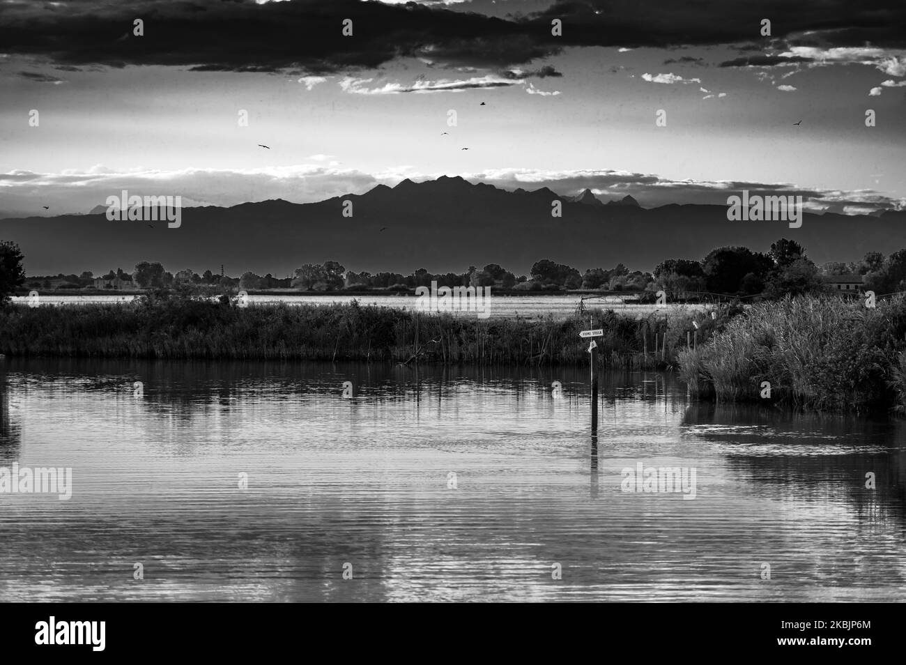 Towards the sunset. Marano lagoon late summer colors. Clouds and sun ...