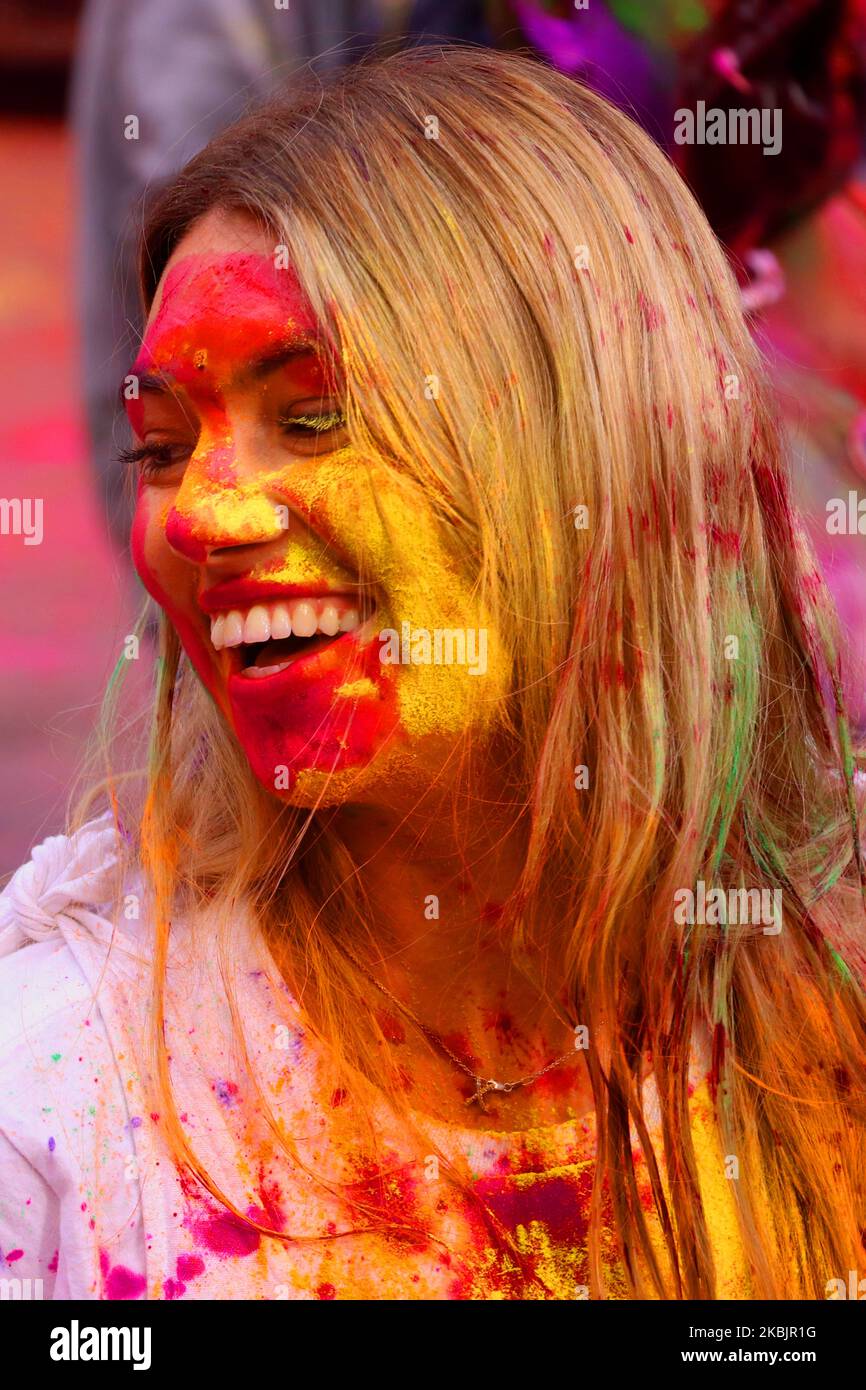 Foreign tourist smeared in colour powder celebrates the Holi, the ...