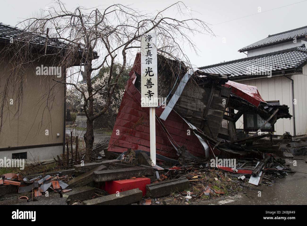 A signboard of the temple with a destroyed entrance in Futaba ...