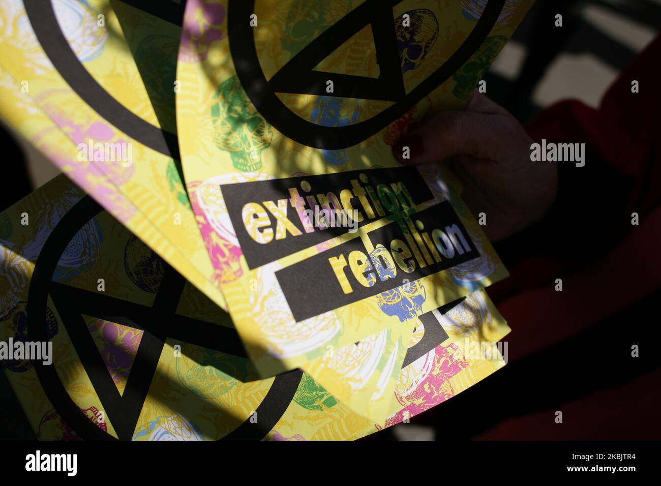 A member of climate change activist movement Extinction Rebellion hands ...