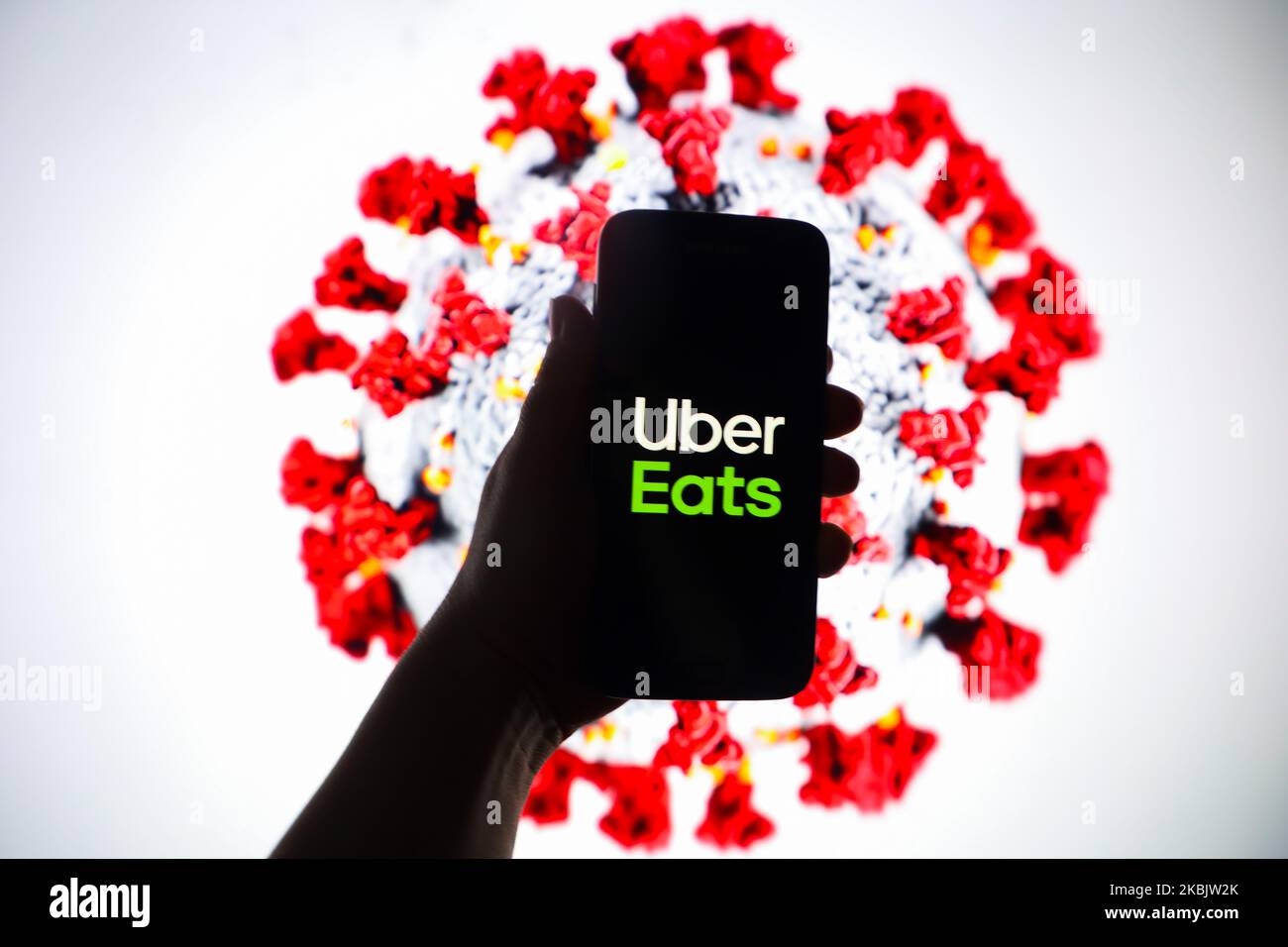 Uber Eats logo is displayed on a mobile phone screen photographed on ...