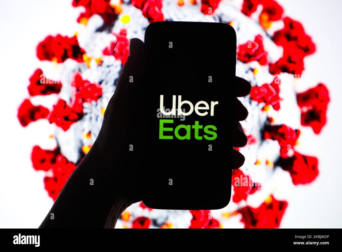 Uber Eats logo is displayed on a mobile phone screen photographed on ...