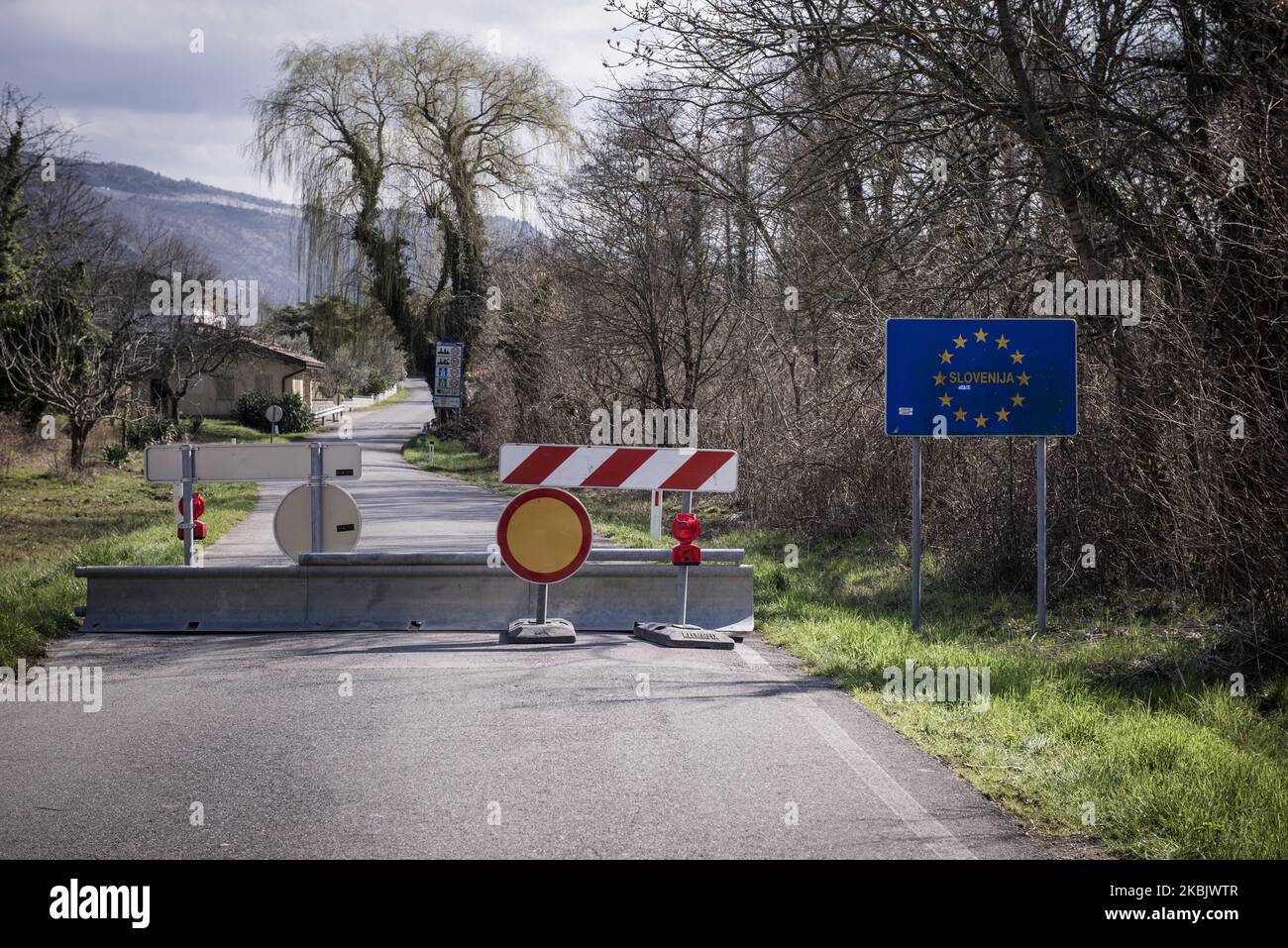 A barrier blocks the road on the border between Italy and Slovenia. To ...