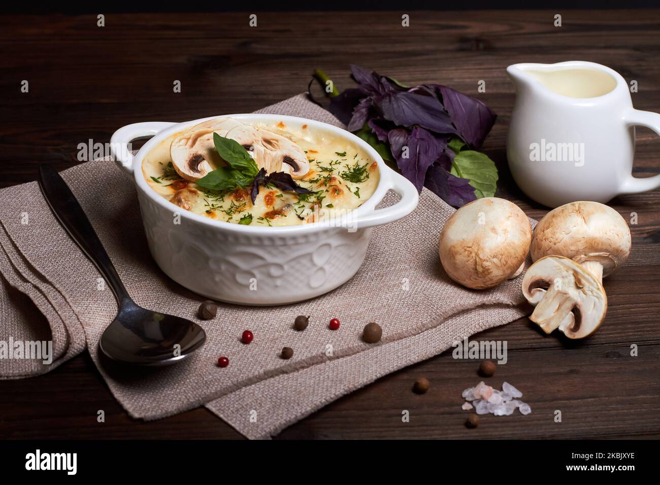 Chicken julienne with cheese, mushrooms and herbs in white plate on ...