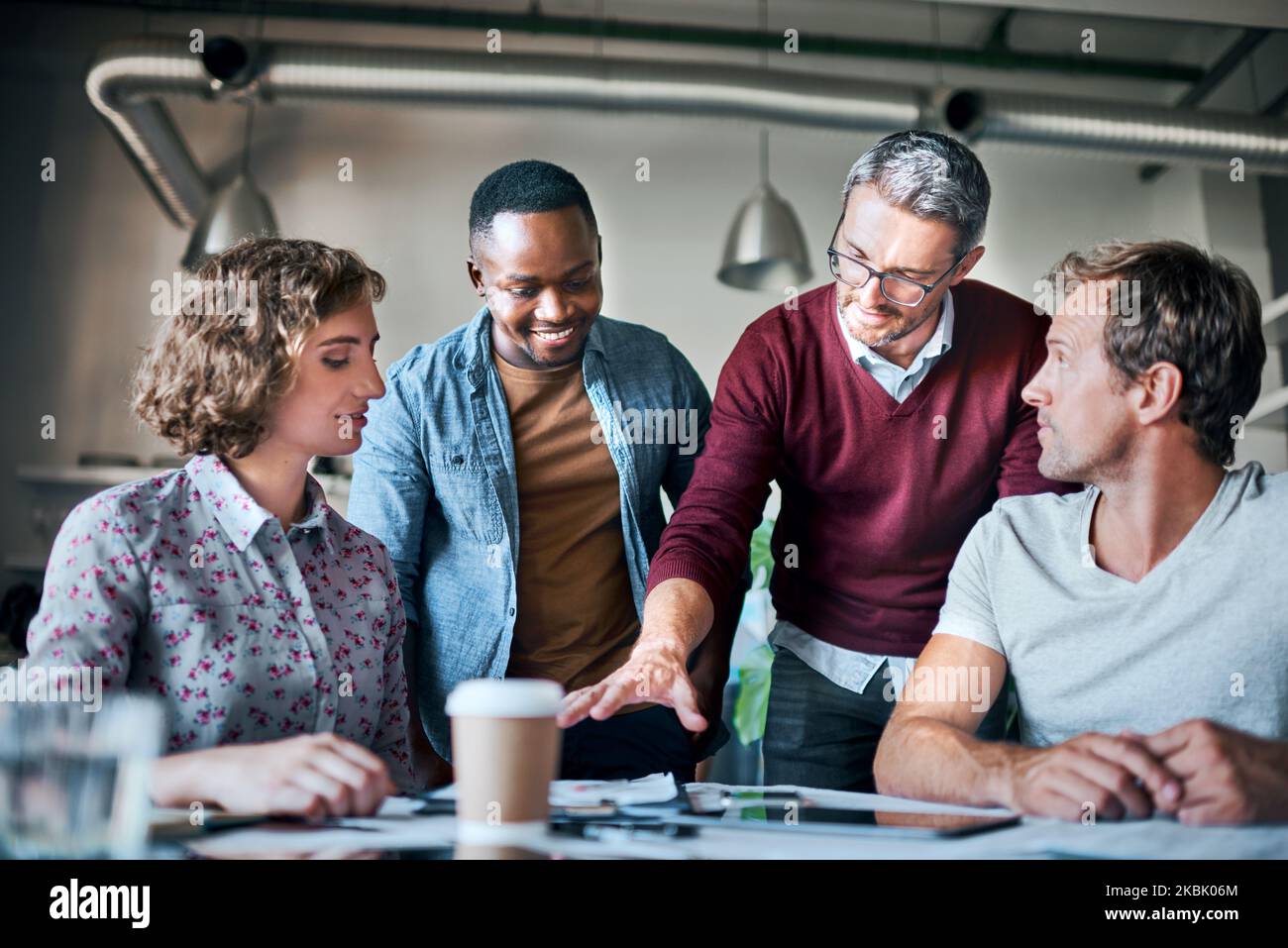 Let me explain this again. a creative business team having a meeting ...