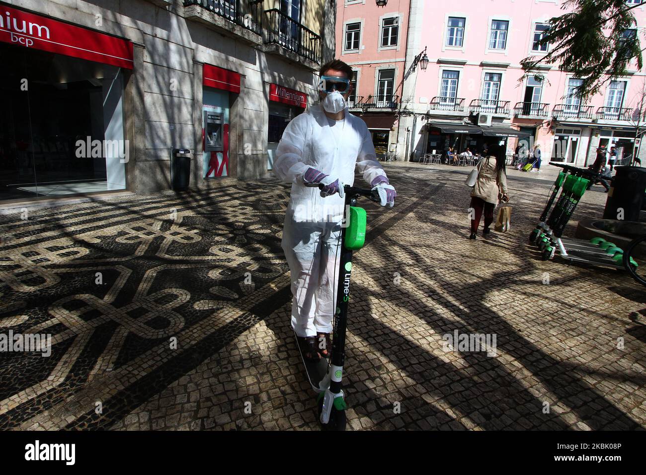 Tourist wear protective masks near the historical zone in Lisbon ...
