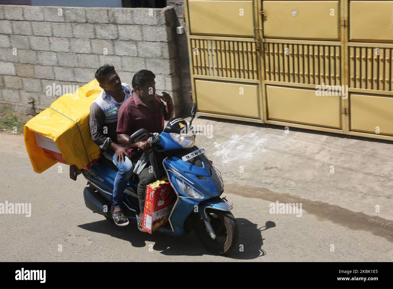 Men carry large boxes on a scooter in Padmanabhapuram, Tamil Nadu ...