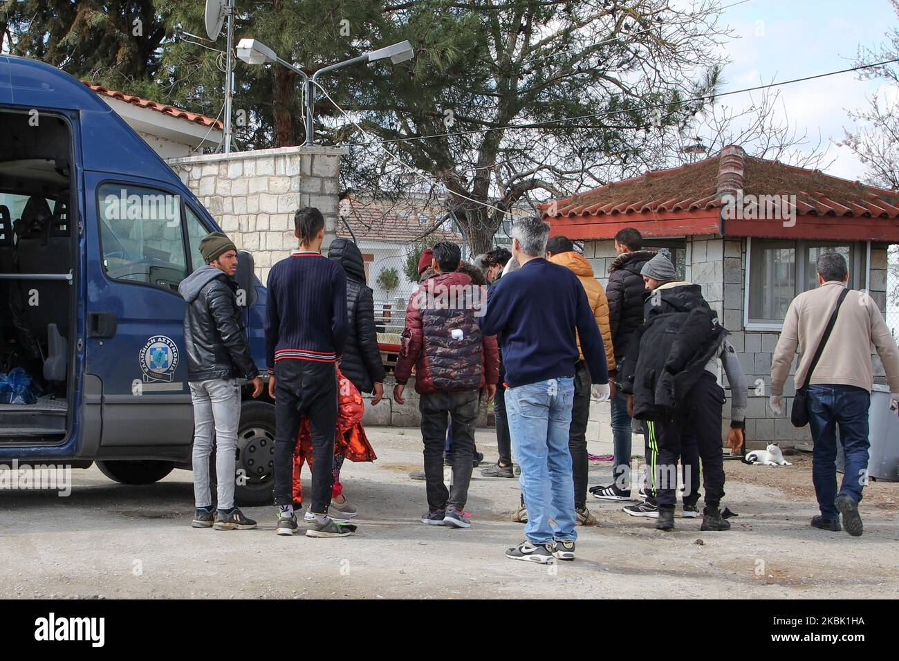 Greek police officers and border police force, unload handcuffed asylum ...