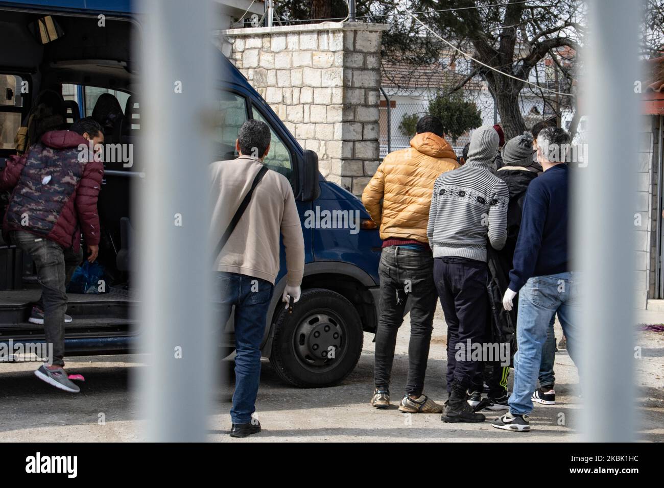 Greek police officers and border police force, unload handcuffed asylum ...