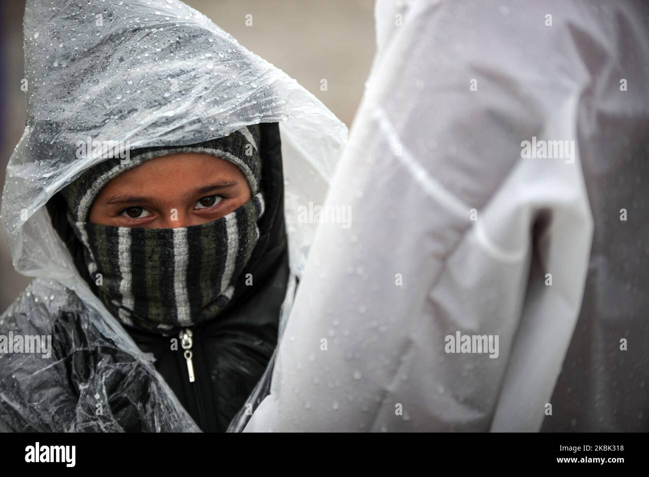 A refugee child is waiting in line for aid from Turkish relief ...