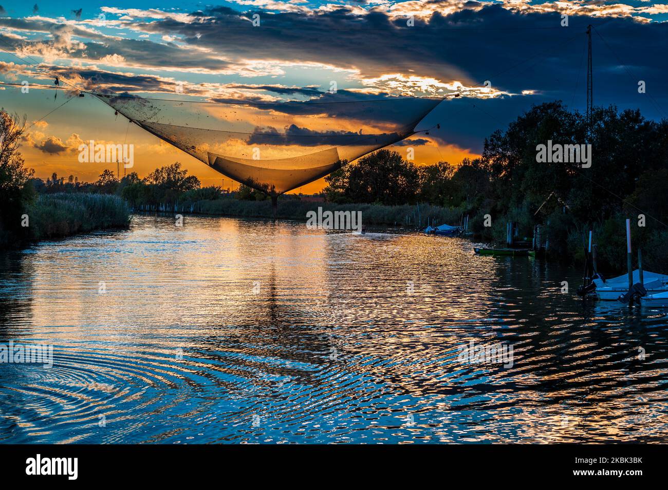 Towards the sunset. Marano lagoon late summer colors. Clouds and sun ...