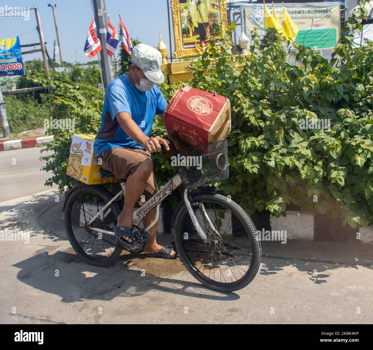 BANGKOK, THAILAND, OCT 30 2022, A man rides a bicycle with beer boxes ...