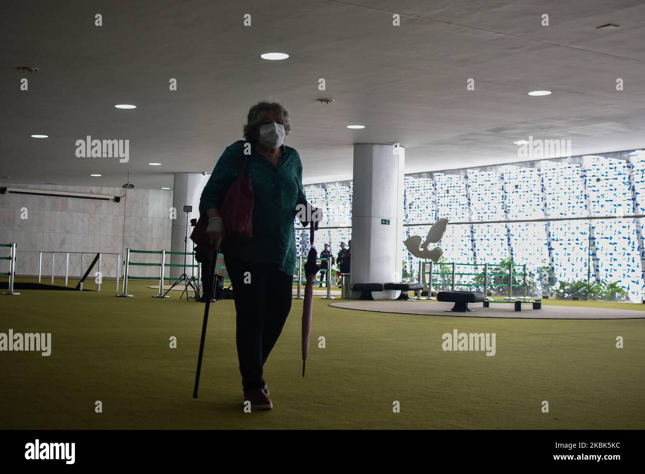A woman wearing face mask at the National Congress, in Brasilia, Brazil ...