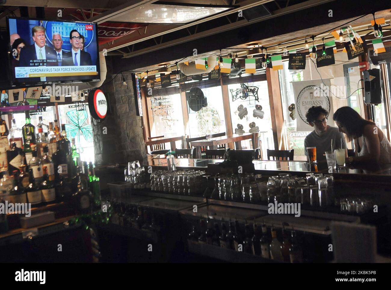 While a White House news conference is broadcast on a television, Ray ...