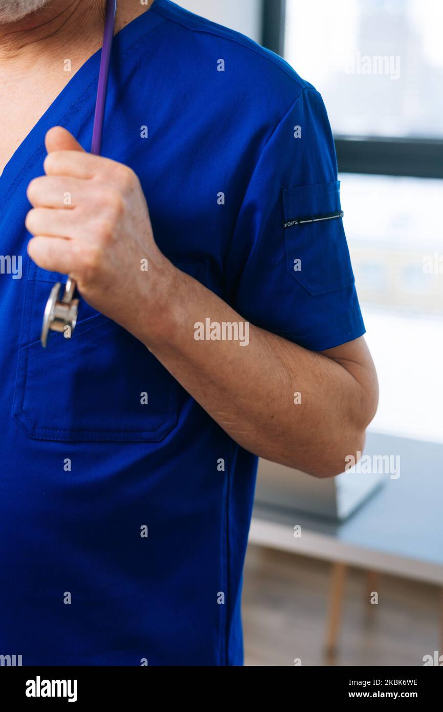 Vertical close-up cropped shot of unrecognizable male doctor wearing ...